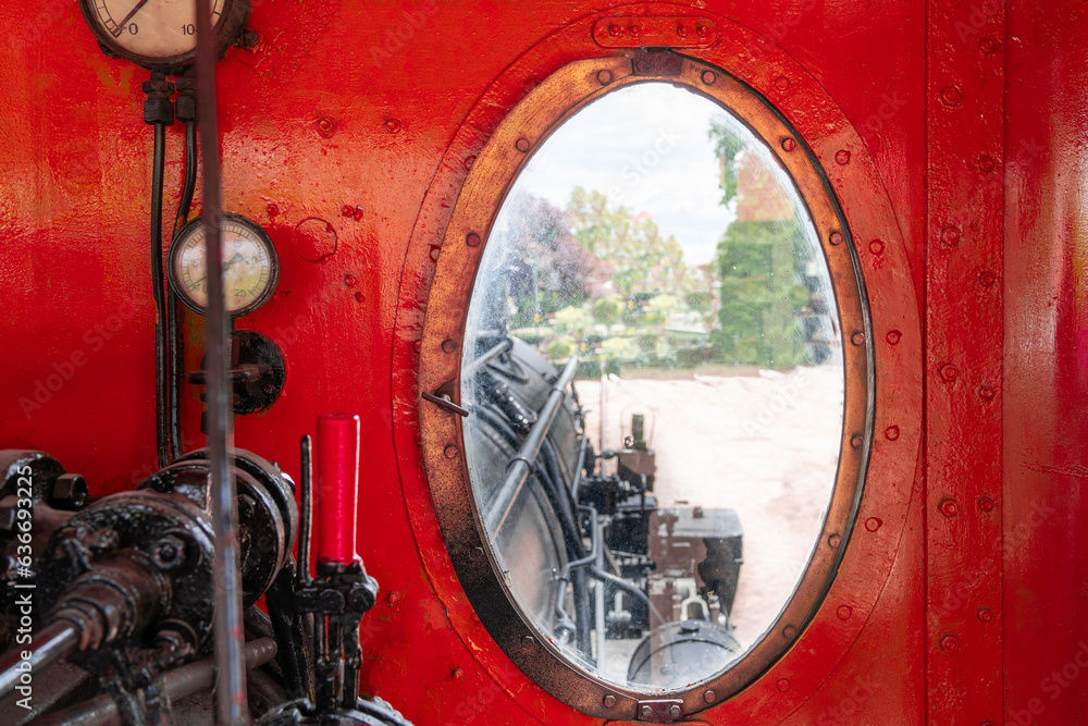 View from the window of the red-painted driver's cab of an old steam ...