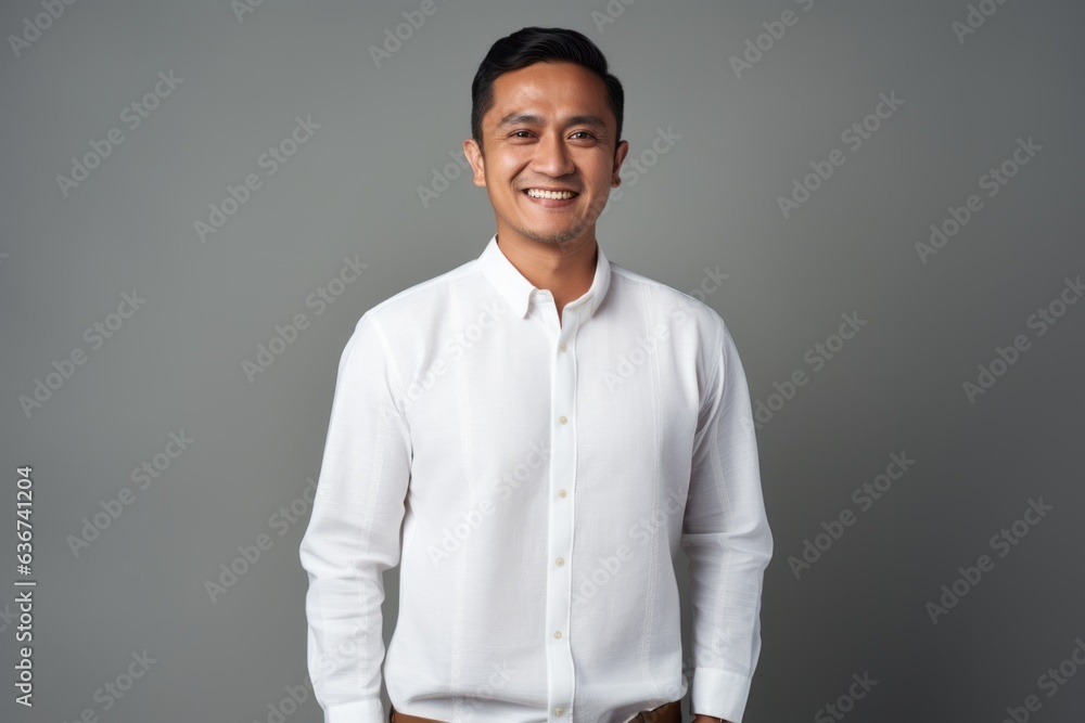 Portrait of a Indonesian man in his 30s in a minimalist or empty room ...