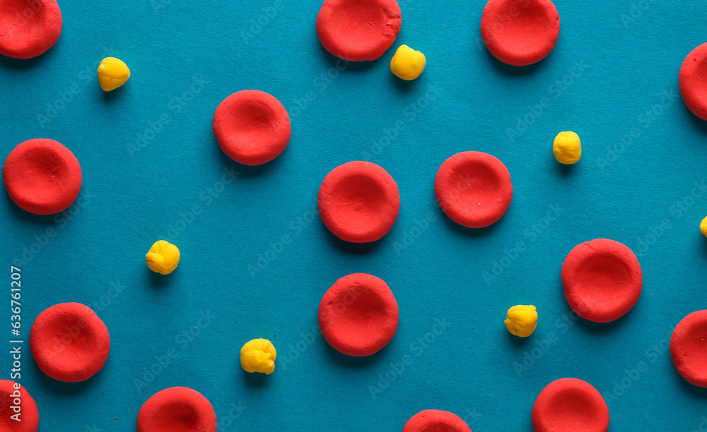 Red blood cells with lipids model made from plasticine on blue ...