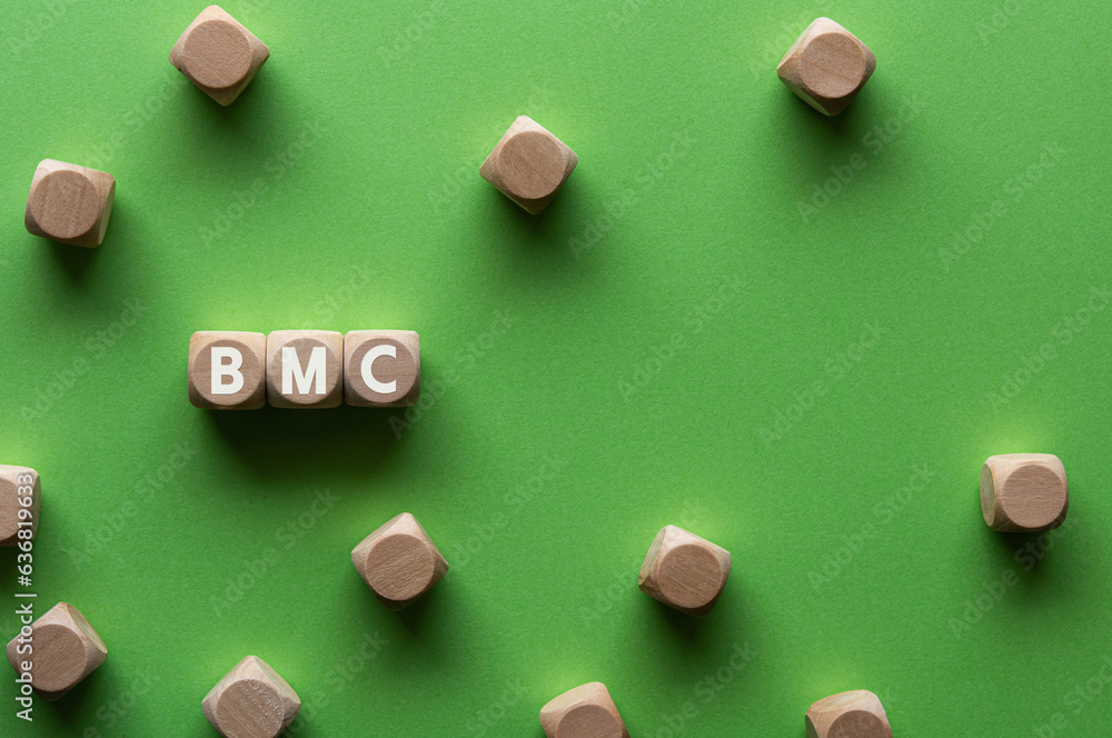 Foto de There is wood cube with the word BMC. It is an abbreviation for ...