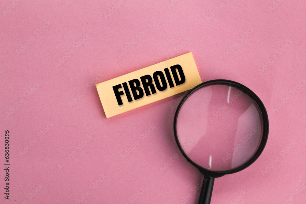 magnifying glass and colored paper with the word Fibroid. concept of ...