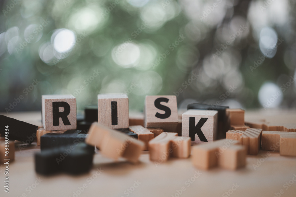 Risk word on wooden block. The concept of reducing risks and financial ...