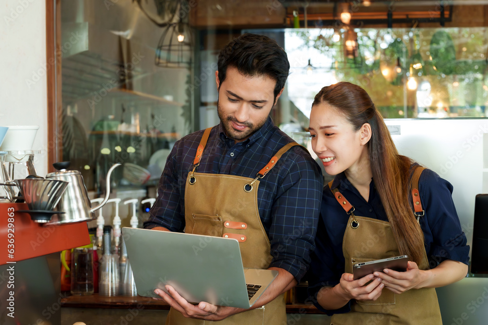 Asian couple runs a bakery and coffee shop together. Indian man holding ...