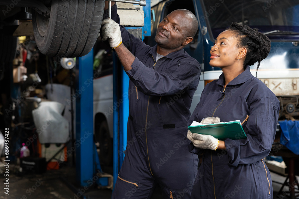 African mechanic workers using lug wrench for fixing a tire in ...
