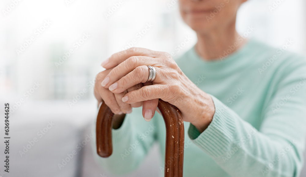 Hands, walking stick and elderly woman with walking stick on a sofa for balance, support and ...