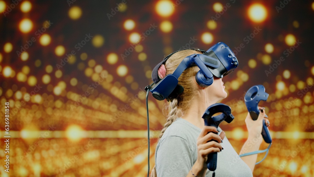 The beautiful woman wearing VR headset dancing in virtual reality. Led ...