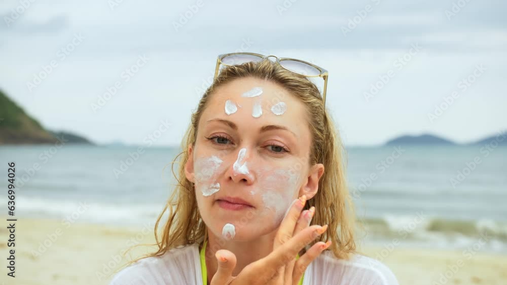Portrait woman applying sun cream protection lotion.Woman looking at ...
