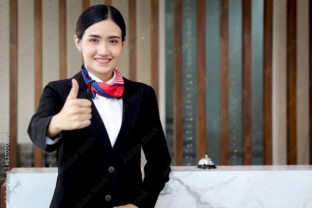 Portrait of happy smiling young beautiful Asian female receptionist in ...