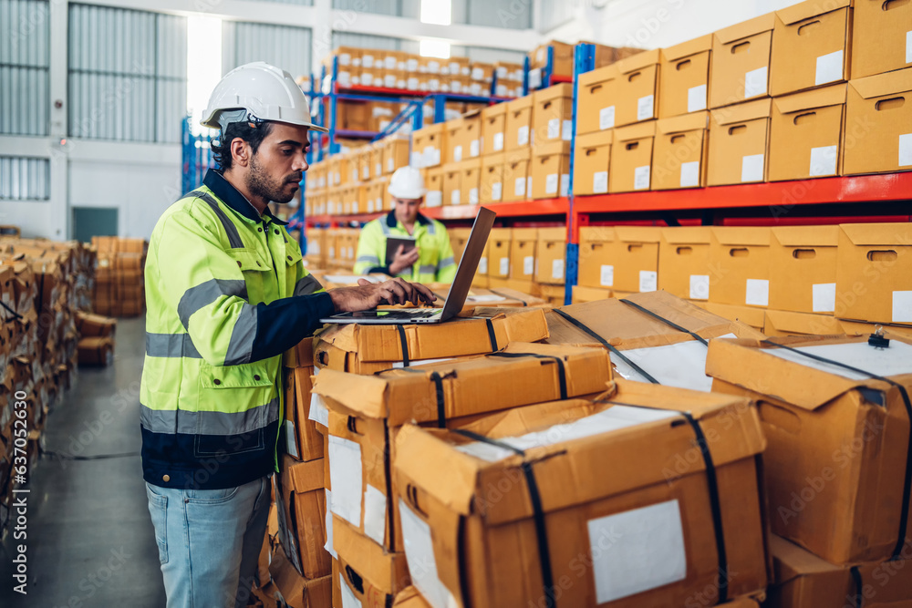 Warehouse worker working in warehouse storage. Foreman or worker work ...
