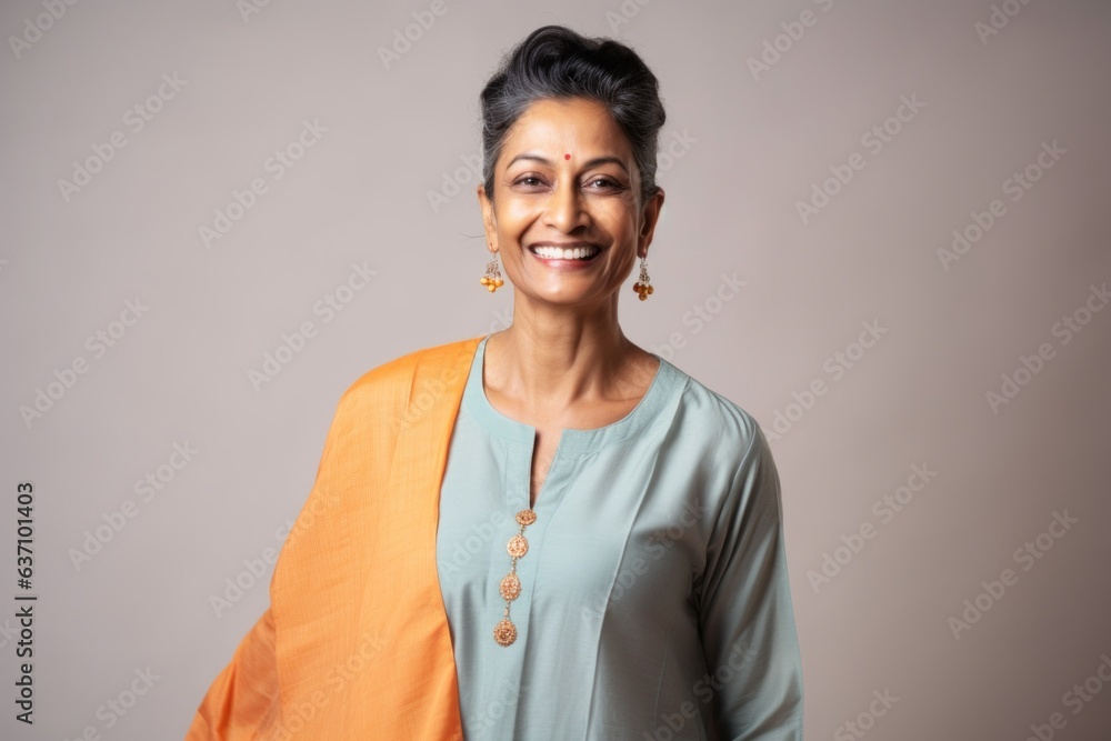 Lifestyle portrait of an Indian woman in her 50s wearing kurta pajama ...