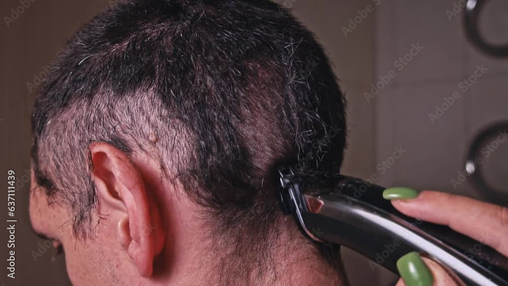 Man haircut with clipper back view in slow mo. Barber giving short ...