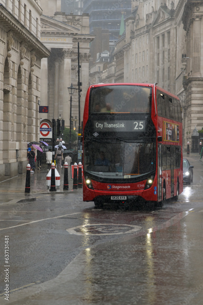 London, UK - July 30, 2023; London red double decker bus in pouring ...