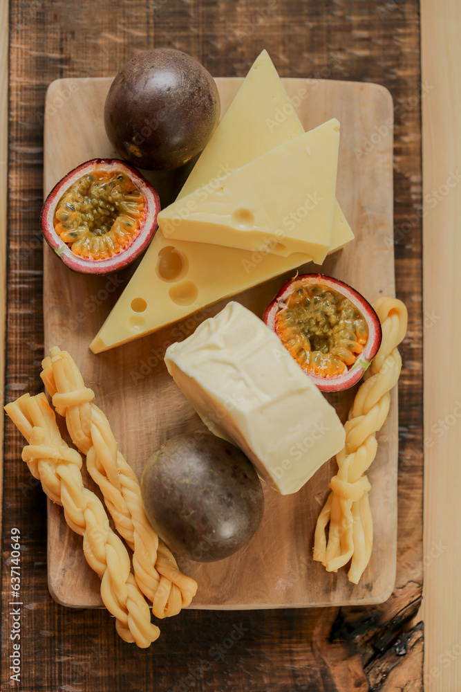 Cheese board with fruits.assorted cheese on a wooden board with herbs ...