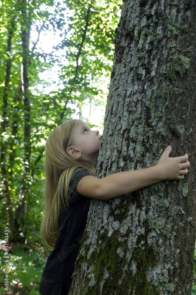 Cute little girl hugging tree. Hugging and touching trees provide rich ...