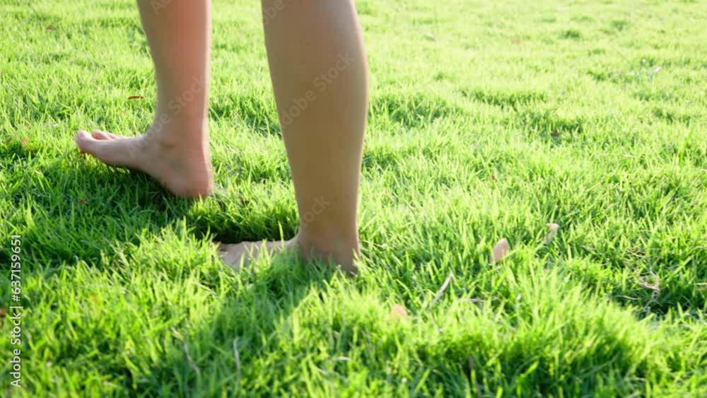 Bare feet walking on the grass. Close up shot of barefoot stepping on ...