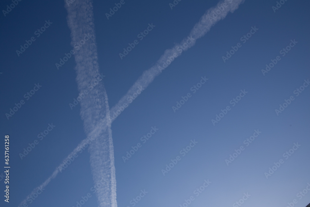 Chemical trails in the sky Stock Photo | Adobe Stock