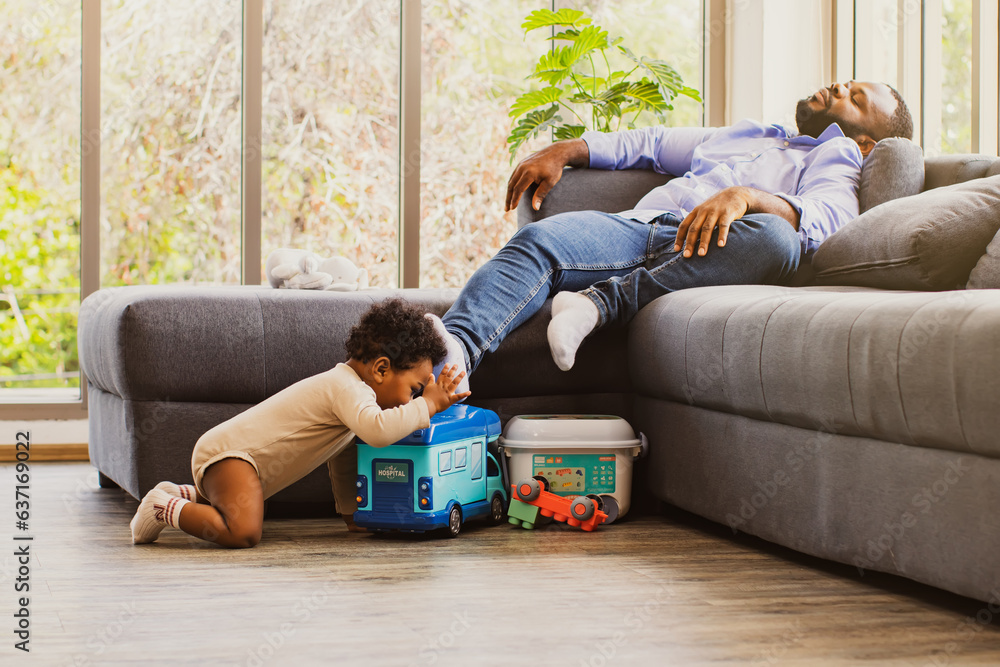 Exhausted exhausted African American father napping on sofa from ...