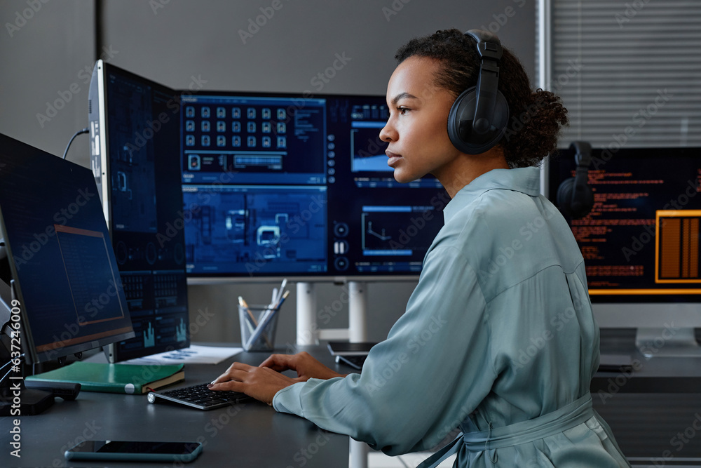 Young computer programmer coding and working on desktop PC at desk ...