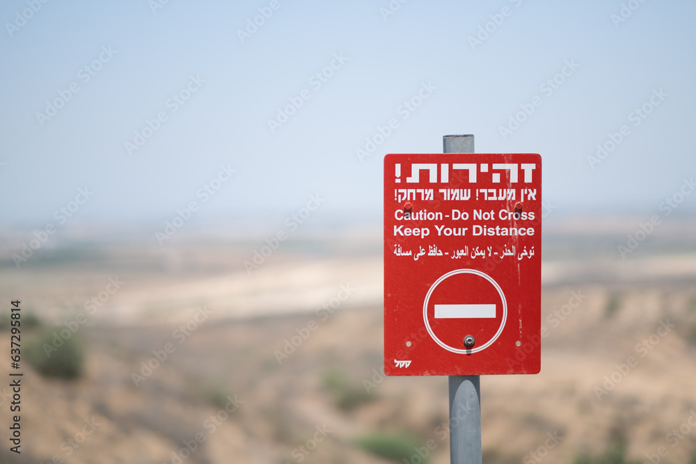 A bright red warning sign outside of the Gaza Strip, near the ...