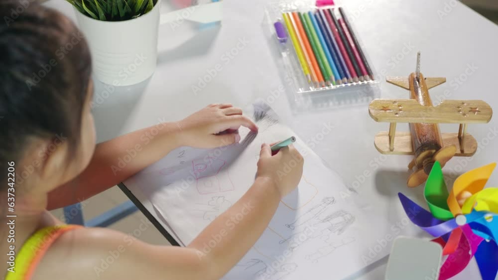 Asian cute kid preschooler sitting on table smiling she draw and ...