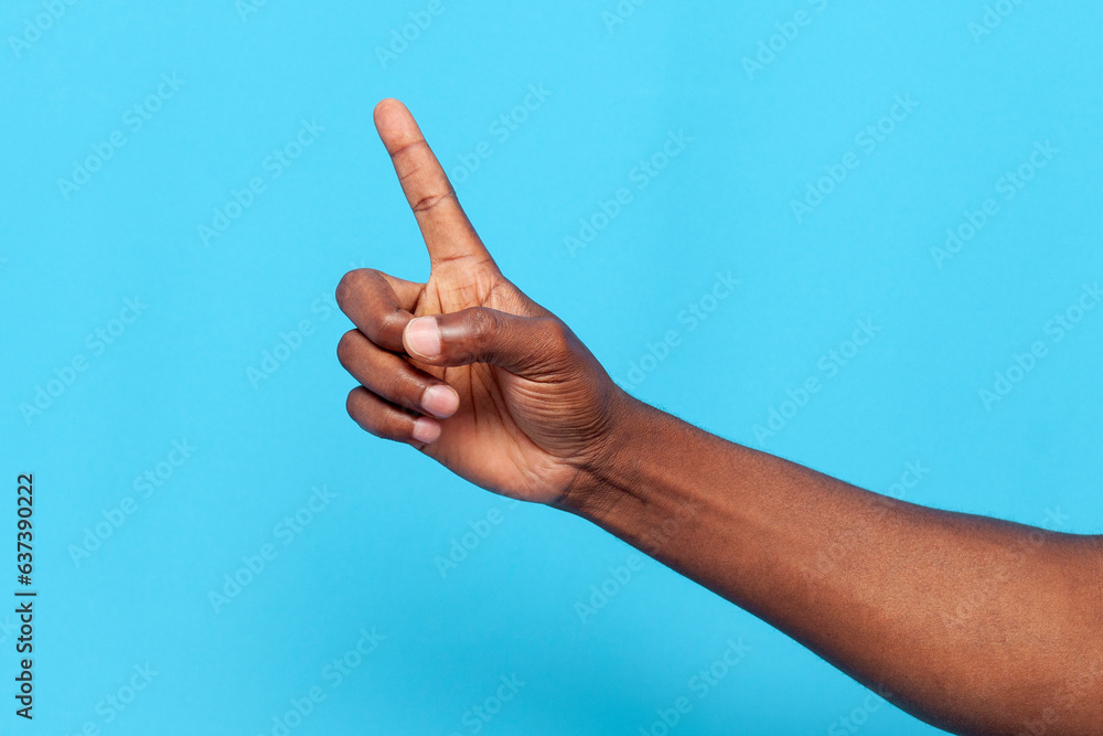 african american male hand pointing finger at copy space on blue ...