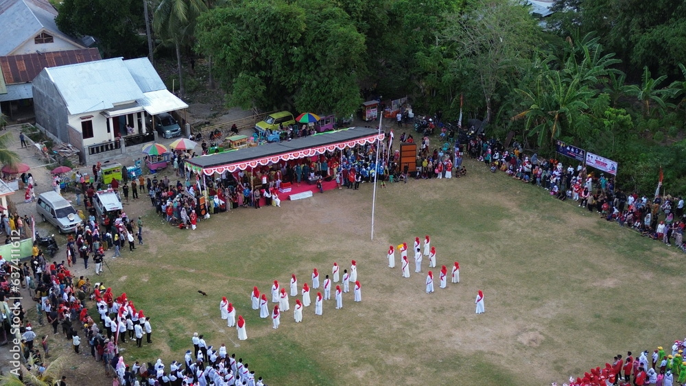 Aerial view of Indonesian flag lowering ceremony witnessed by villagers ...