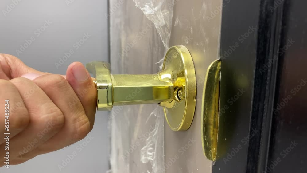 Gold doorknob handle close up shot in office room. Male hand unlock and ...