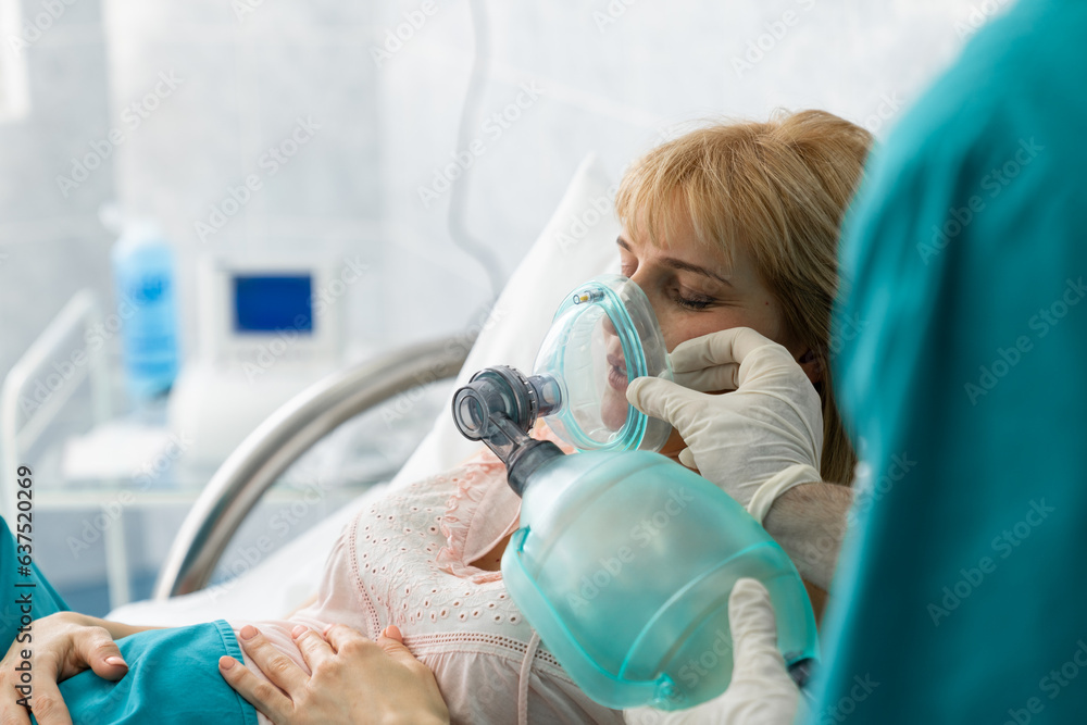 Portrait of worried crying pregnant woman holding her stomach and ...