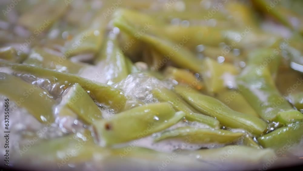 In detail: boiling green beans while cooking. Many bubbles of boiling ...