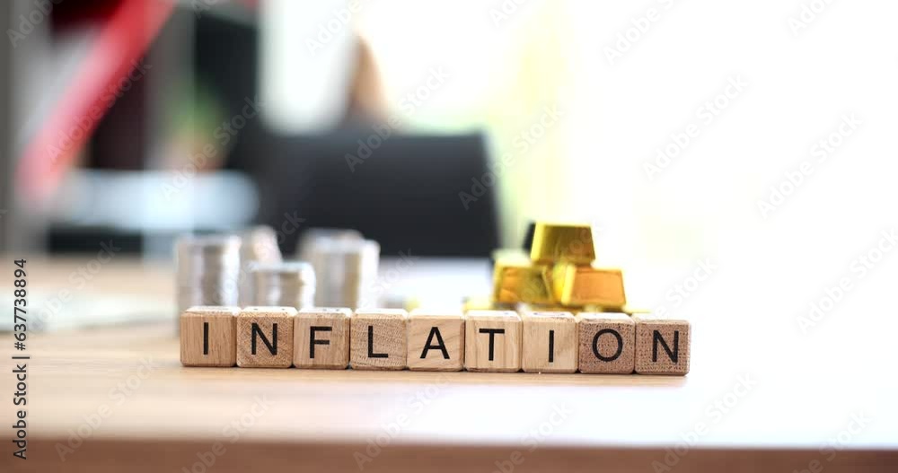 Inflation with gold bars and stacks of coins on table. Rising costs and ...