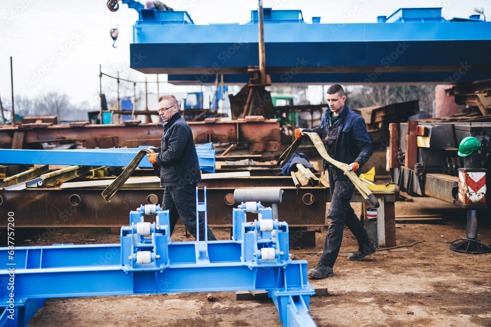 Manual workers working at shipyard construction site Stock Photo ...