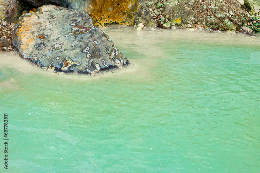 close-up of a cobalt blue hot spring with a large hot spring rock Stock ...