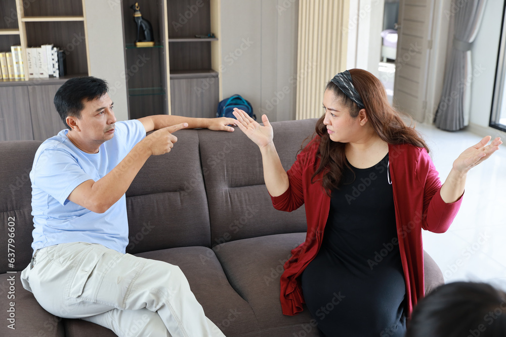 Angry family father and mother have disagreement with something in sofa ...
