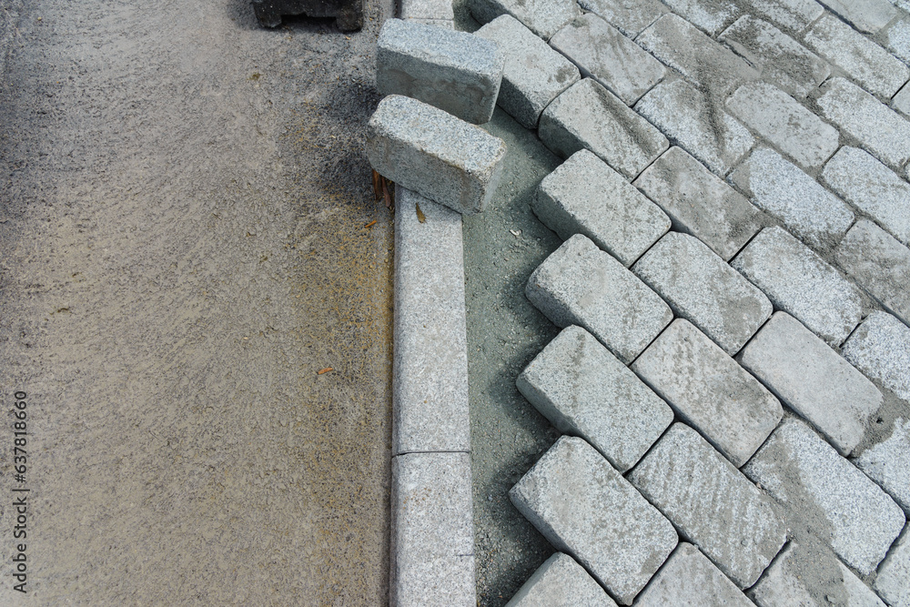 Construction installing and arranging precast concrete pavers stone for ...