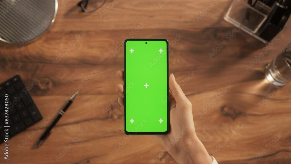 Top Down View of a Person Holding a Smartphone with Mock Up Green ...
