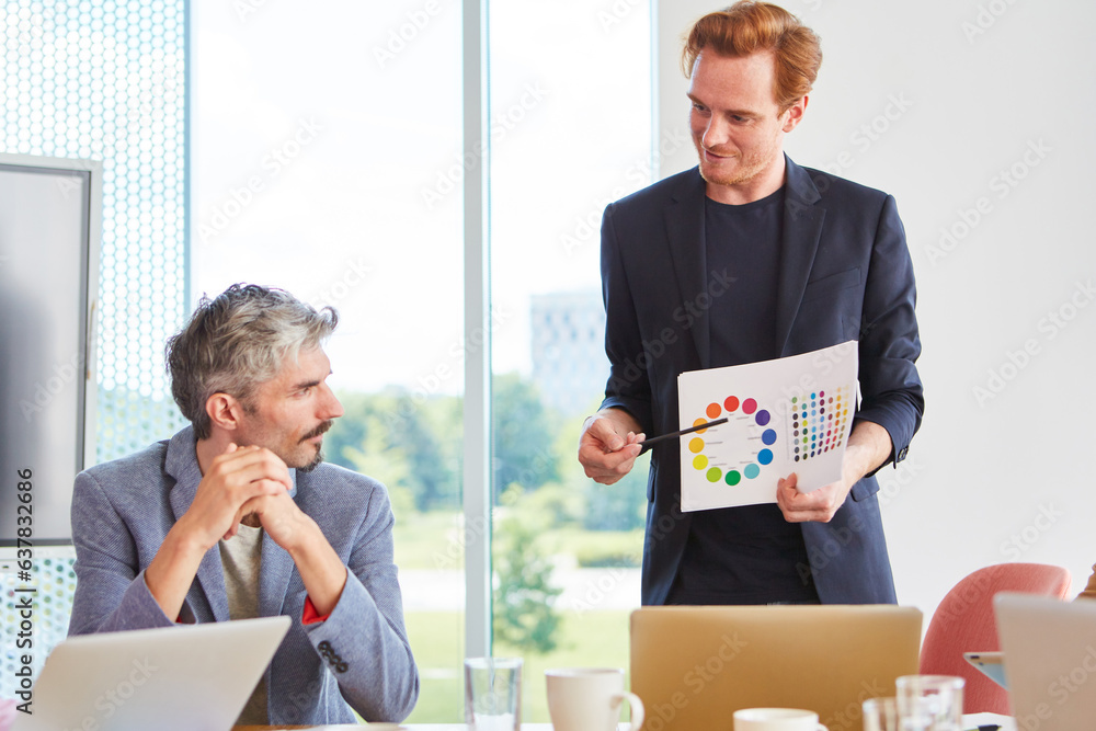 Confident redhead businessman showing chart while giving presentation ...