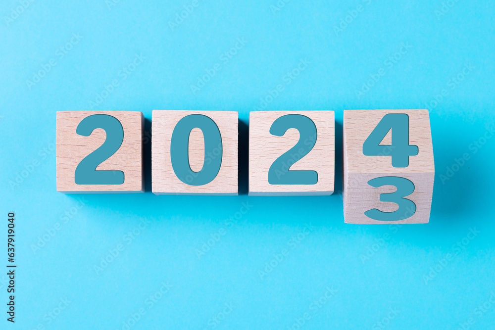 2024 Happy New Year. Wooden cube block 2024 from 2023 to 2024 on blue ...