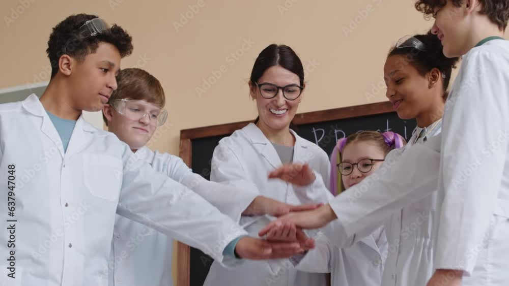 Medium shot of joyful Caucasian female teacher of Chemistry and group ... Medium shot of joyful Caucasian female teacher of Chemistry and group ...