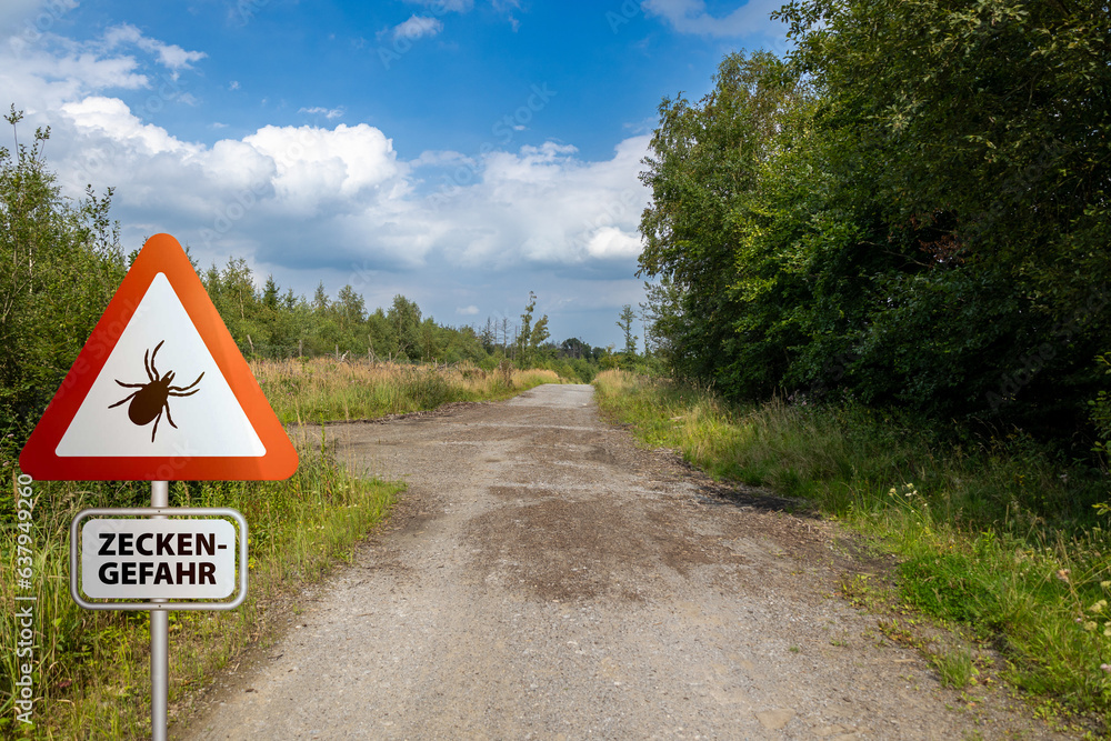 Warning sign for infected ticks in a forest. Risk of tick and Lyme ...