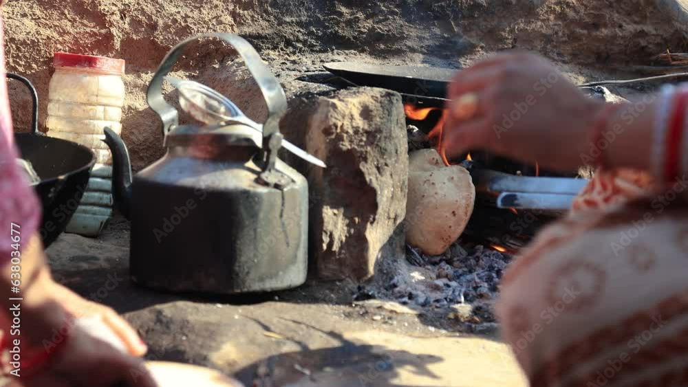 Close up of hands of an Asian female making roti in the kitchen ...