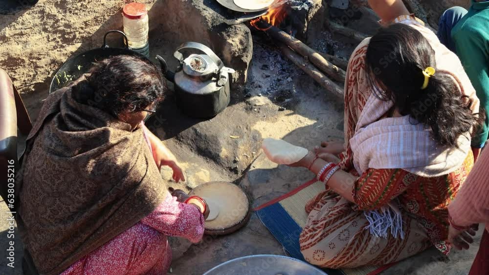 Close up of hands of an Asian female making roti in the kitchen ...