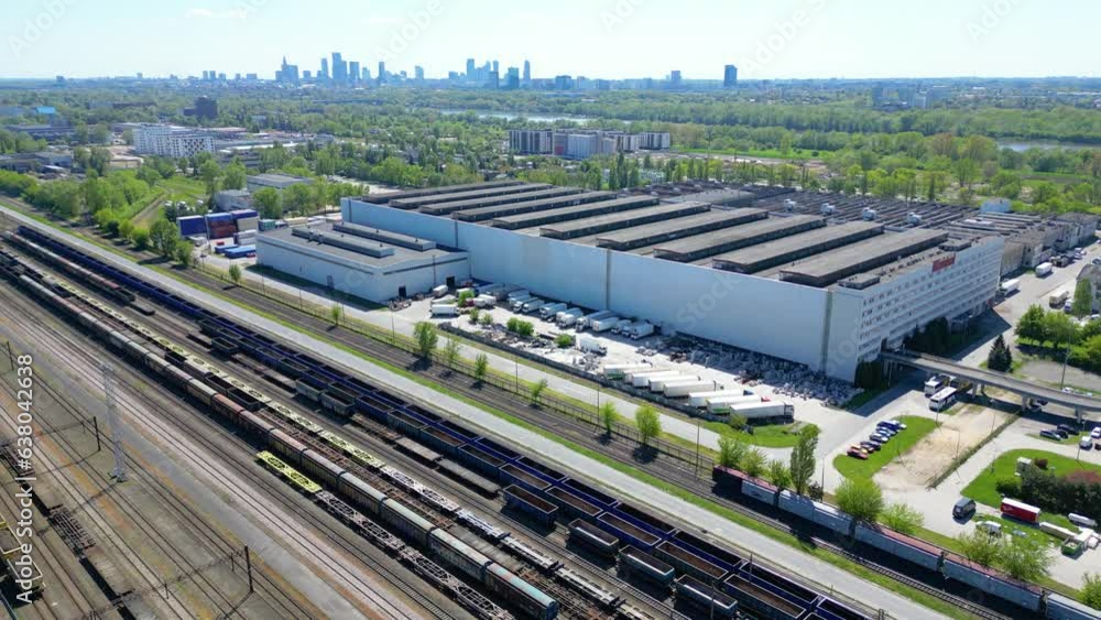 Flying above industrial railroad station with cargo trains and freight ...