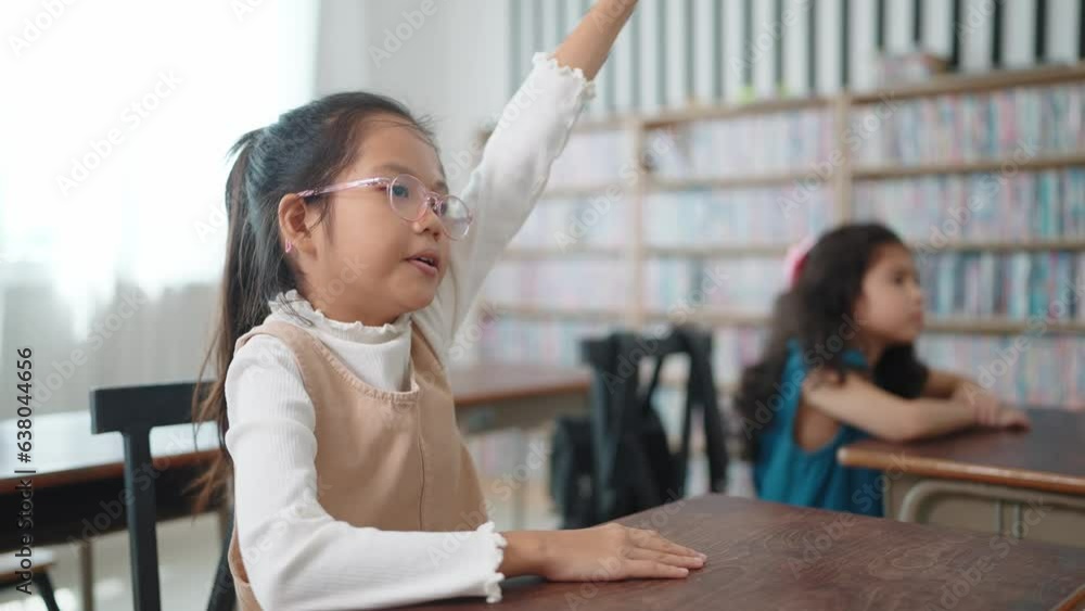 Active excellent Asian student schoolgirl in glasses raising hands up ...