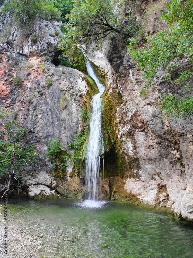 Water stream of mountain waterfall flowing between picturesque rocks ...