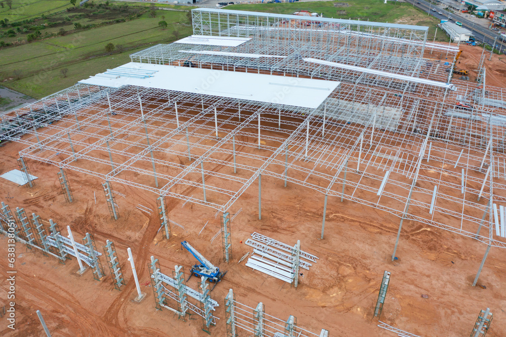 Aerial view of busy industrial under construction site workers working ...