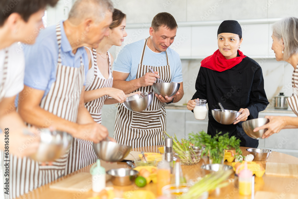 Positive young Asian woman professional chef conducting culinary ...