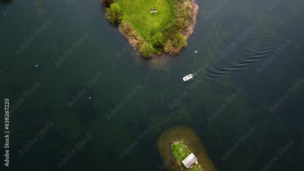 Aerial from the top view of a boat (Yacht) crossing a water channel ...