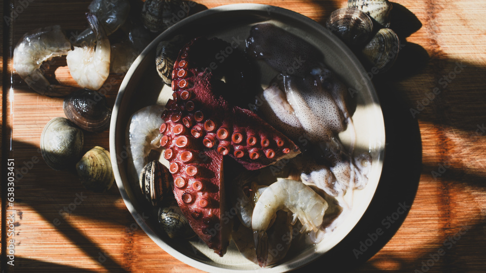 Raw seafood dish composed of octopus, shrimp, clamps and squid Stock ...