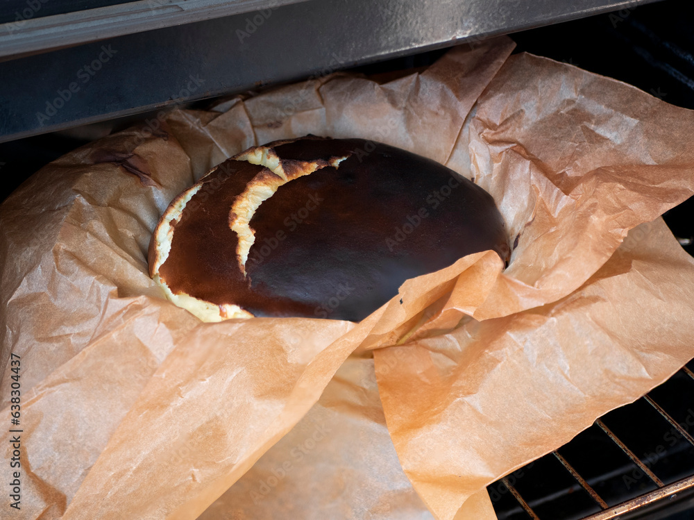 Basque Burnt Cheesecake in the parchment paper, ready to be cut, plated ...