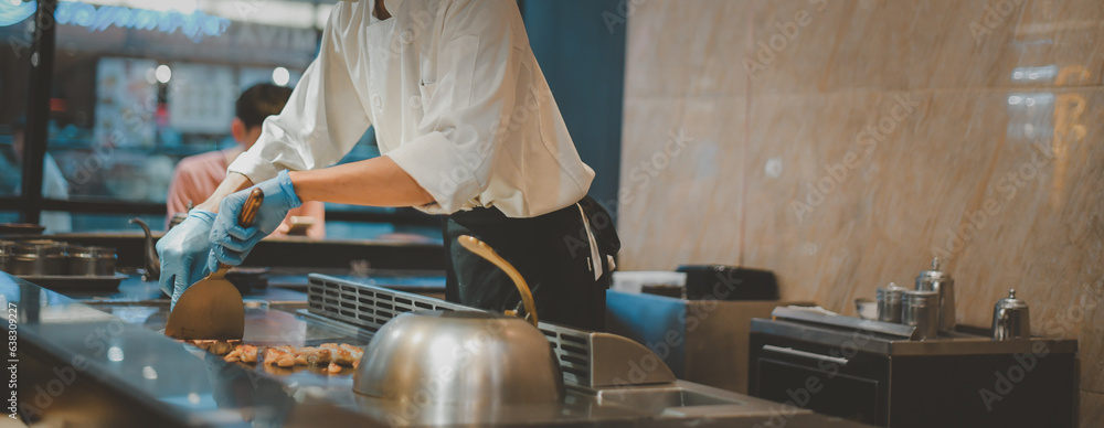 Focus hand Japanese deliberately cuisine chef cooking work hot table ...